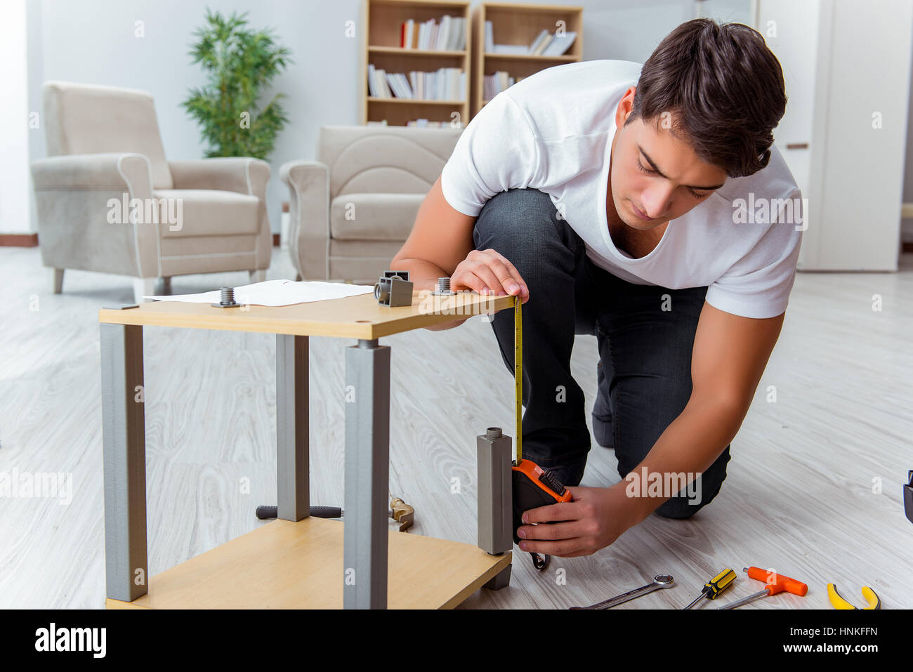 Man assembling furniture at home Stock Photo - Alamy