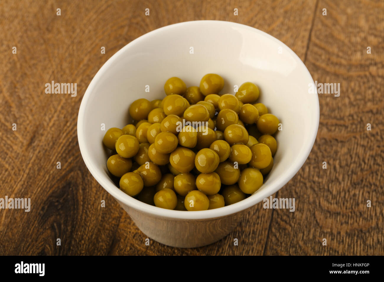 Pickled green pea on the wood background Stock Photo - Alamy