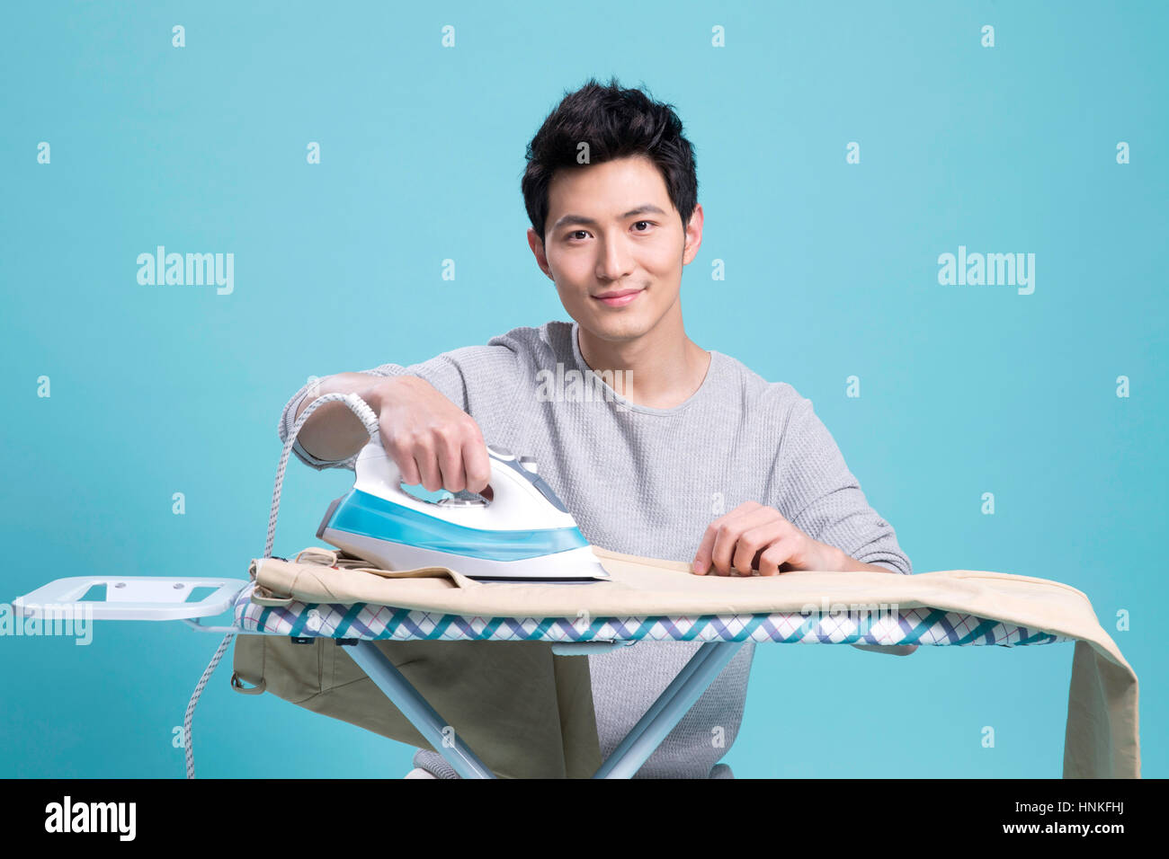 Young men do housework Stock Photo - Alamy