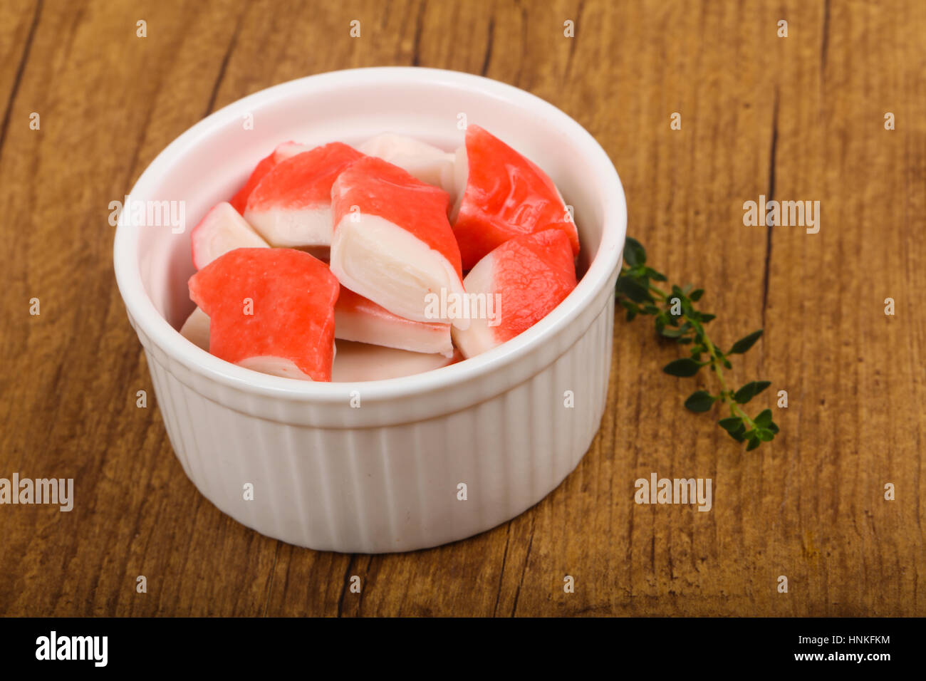 Crab stick - surimi in the plate - over wood background Stock Photo - Alamy