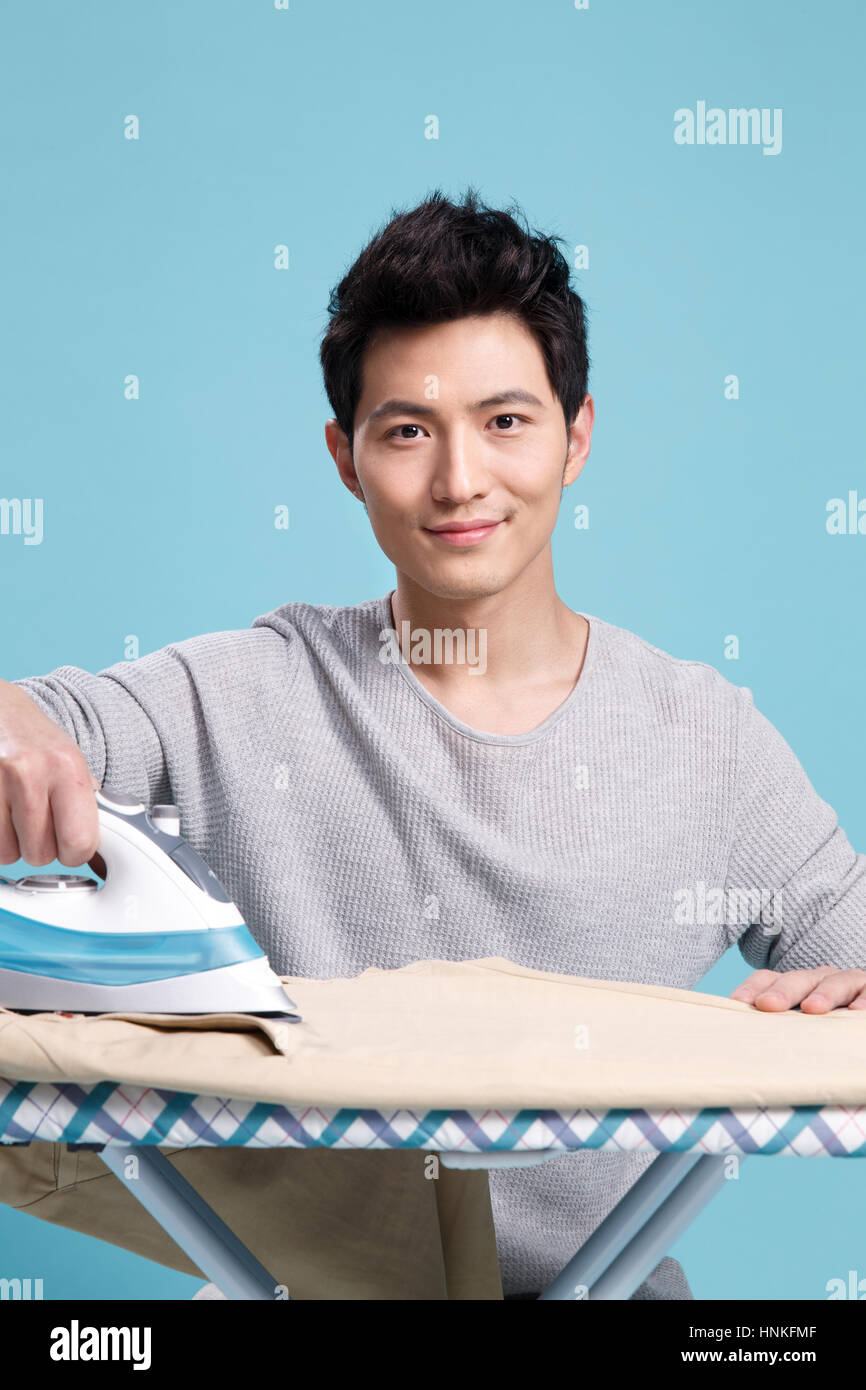Young men do housework Stock Photo - Alamy