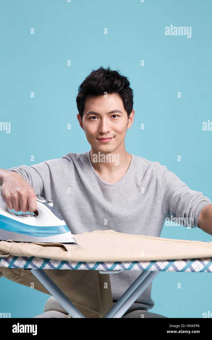 Young men do housework Stock Photo - Alamy