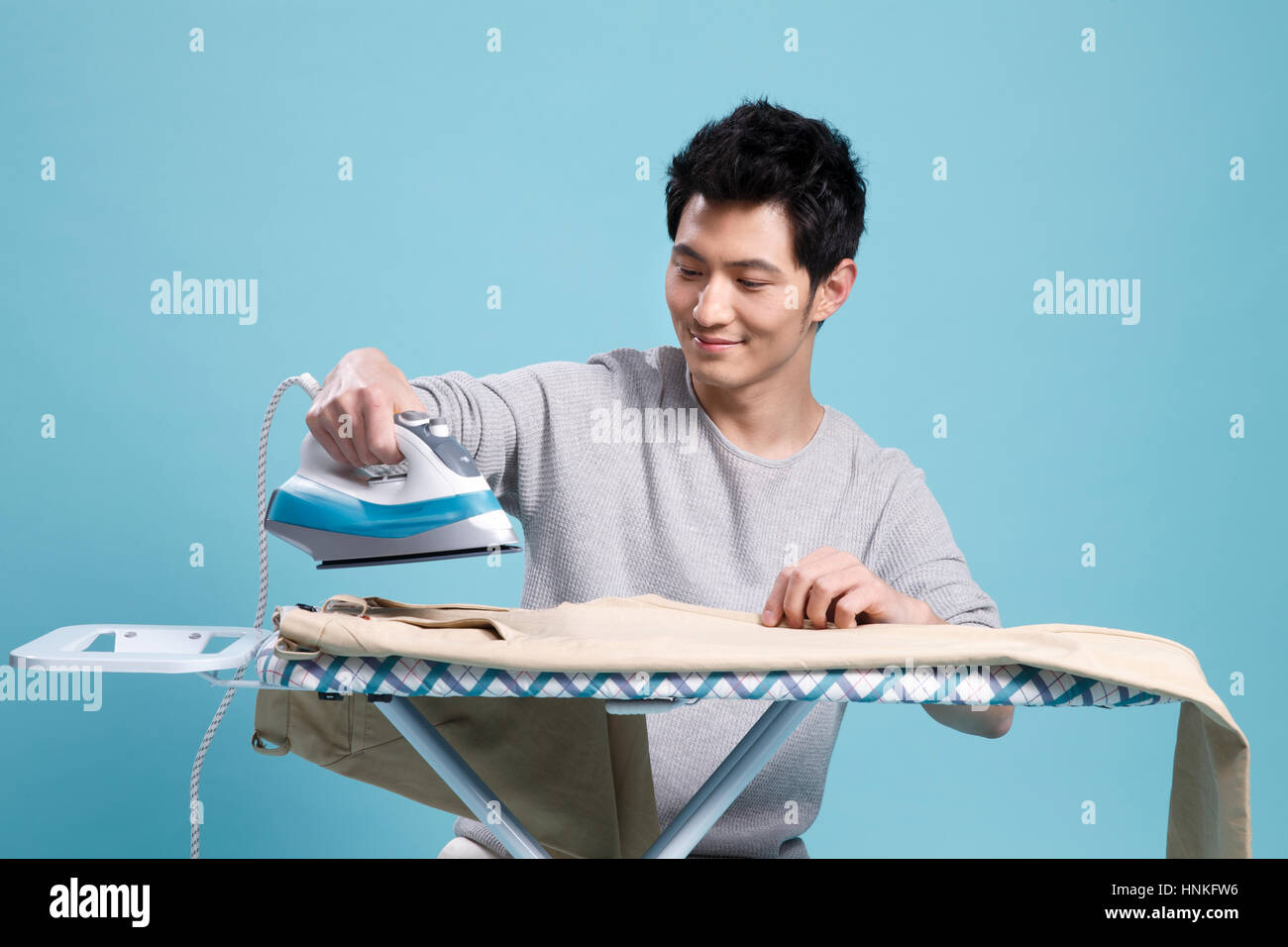 Young men do housework Stock Photo - Alamy