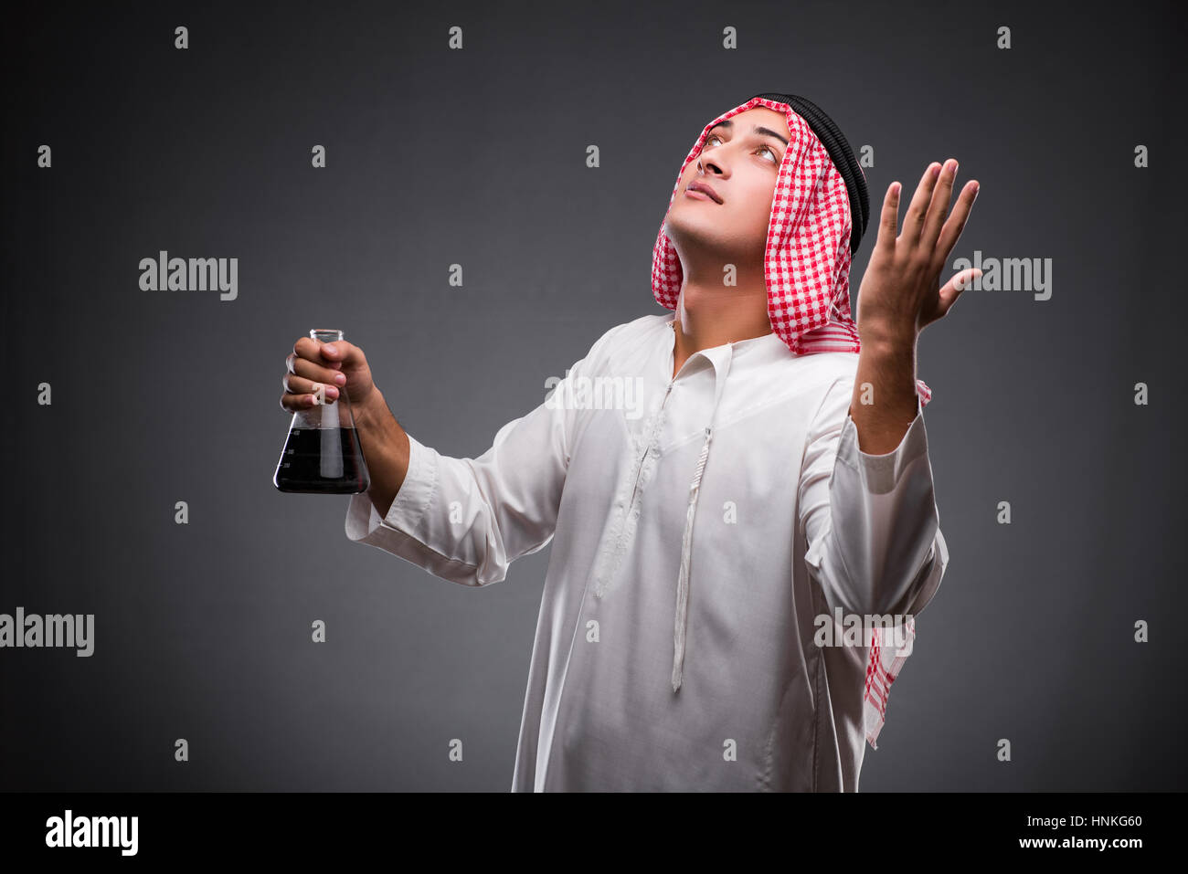 Arab with oil on gray background Stock Photo - Alamy
