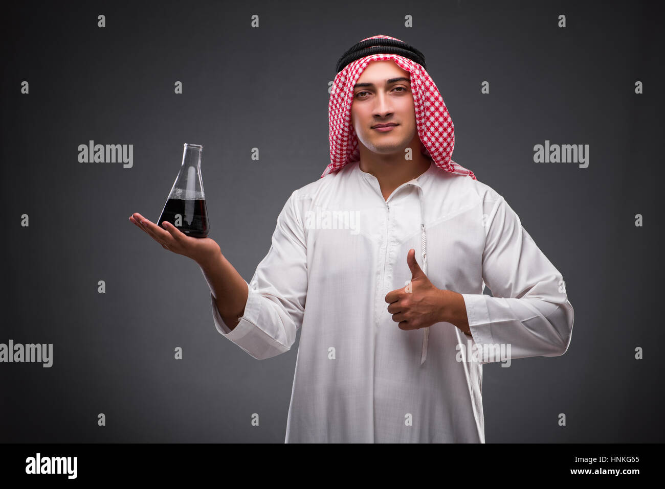 Arab with oil on gray background Stock Photo - Alamy