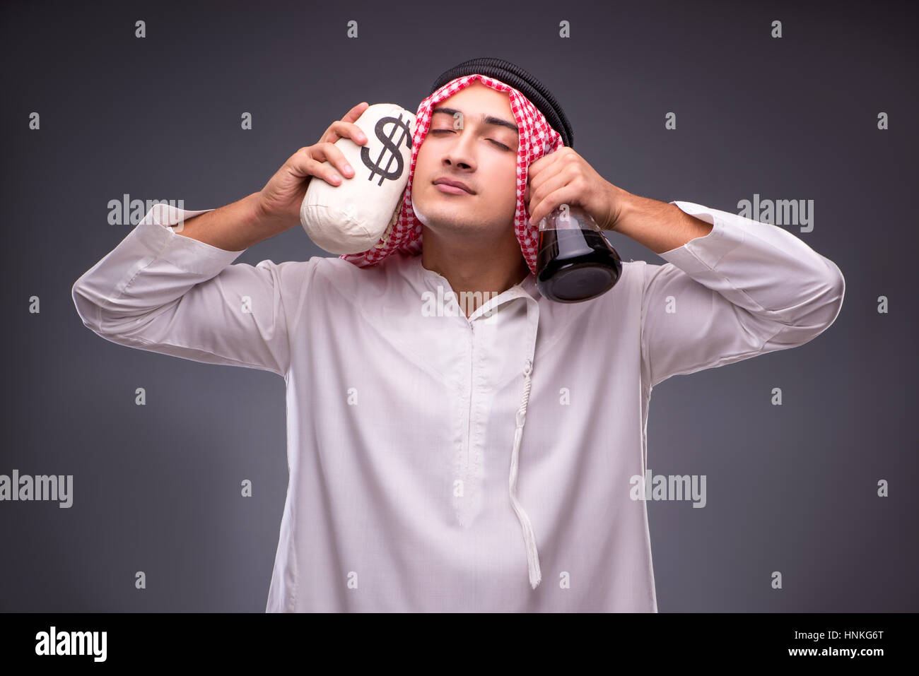 Arab with oil on gray background Stock Photo - Alamy