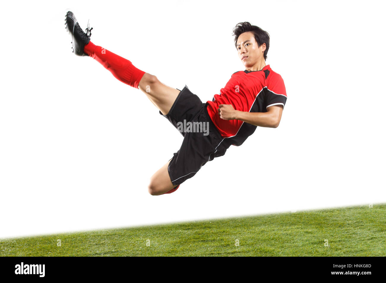 Asian soccer player kicking ball hi-res stock photography and images ...