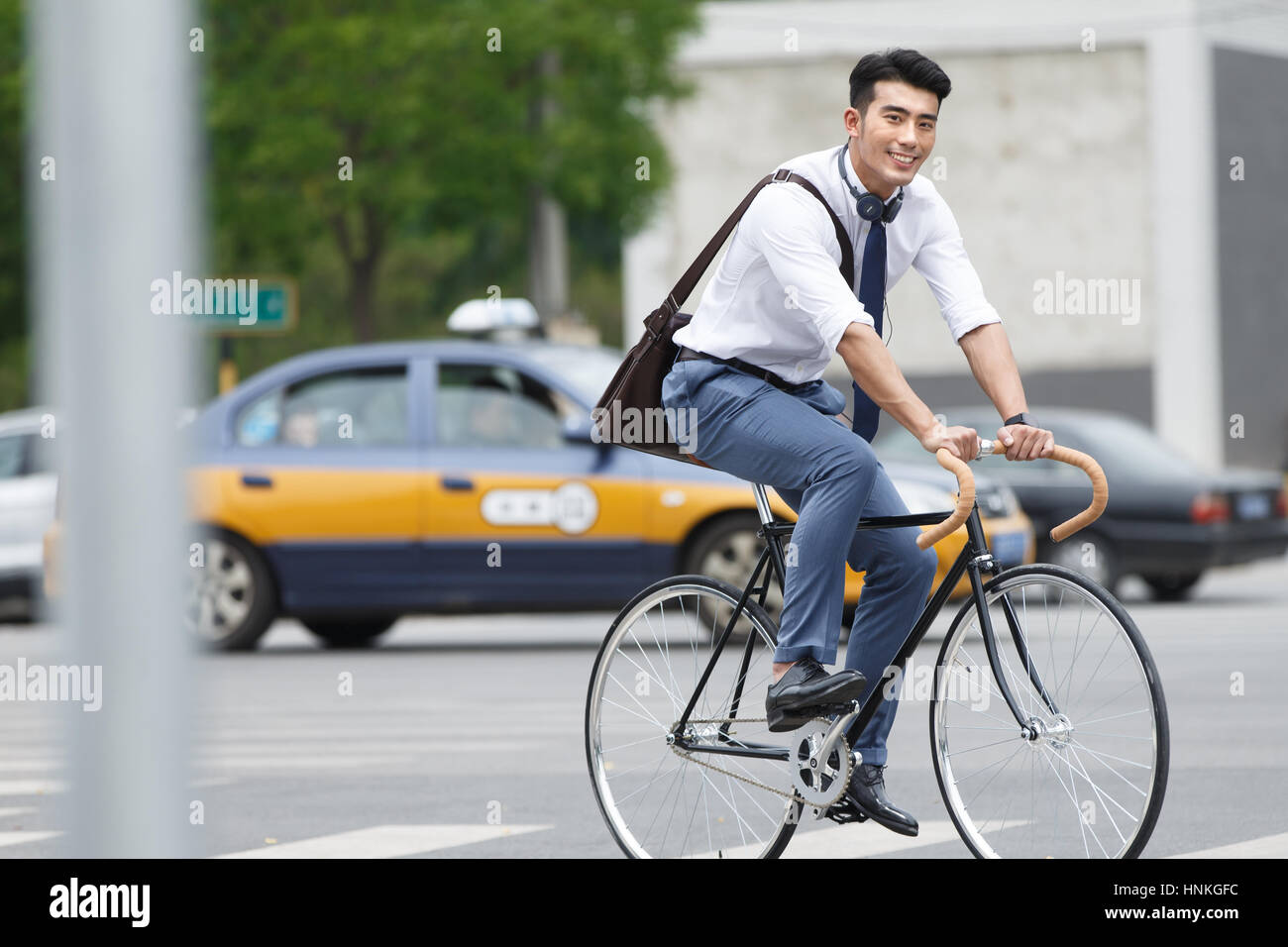 Young man riding a bicycle Stock Photo - Alamy