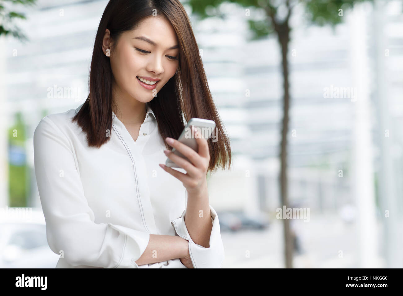 Young women using mobile phones Stock Photo - Alamy