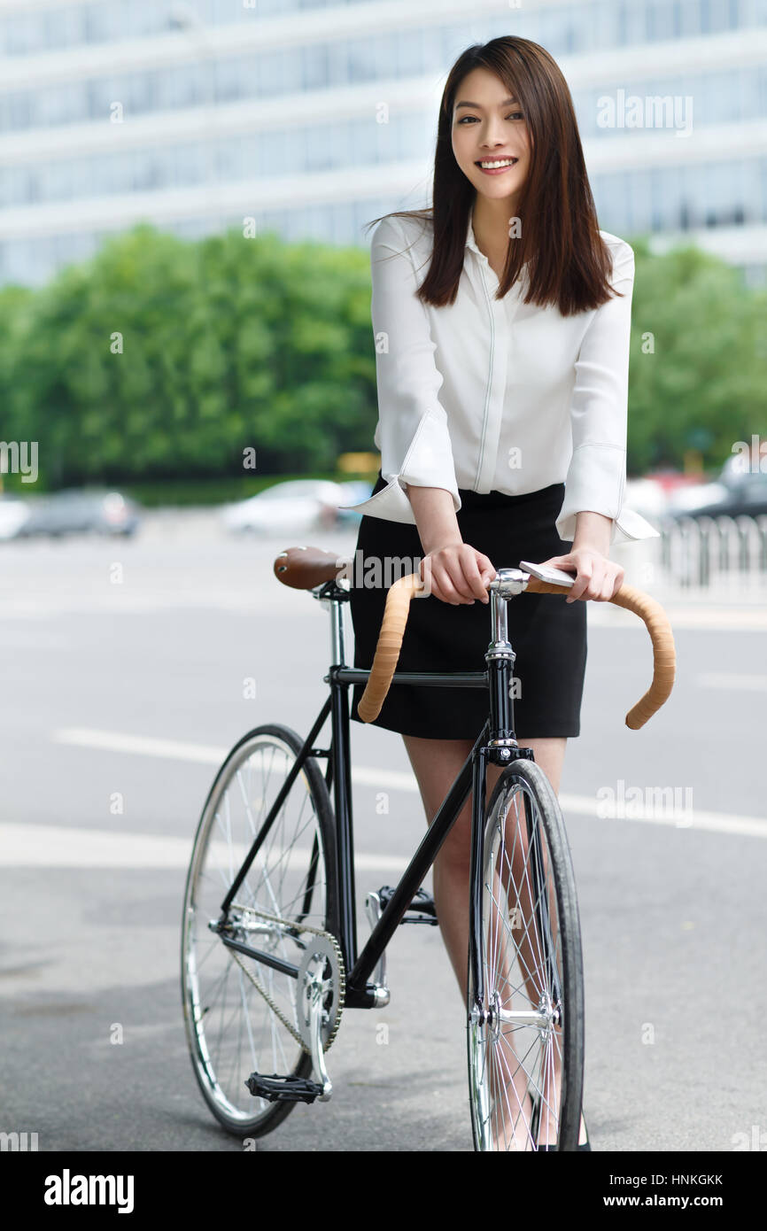 Woman pushing her bicycle hi-res stock photography and images - Alamy