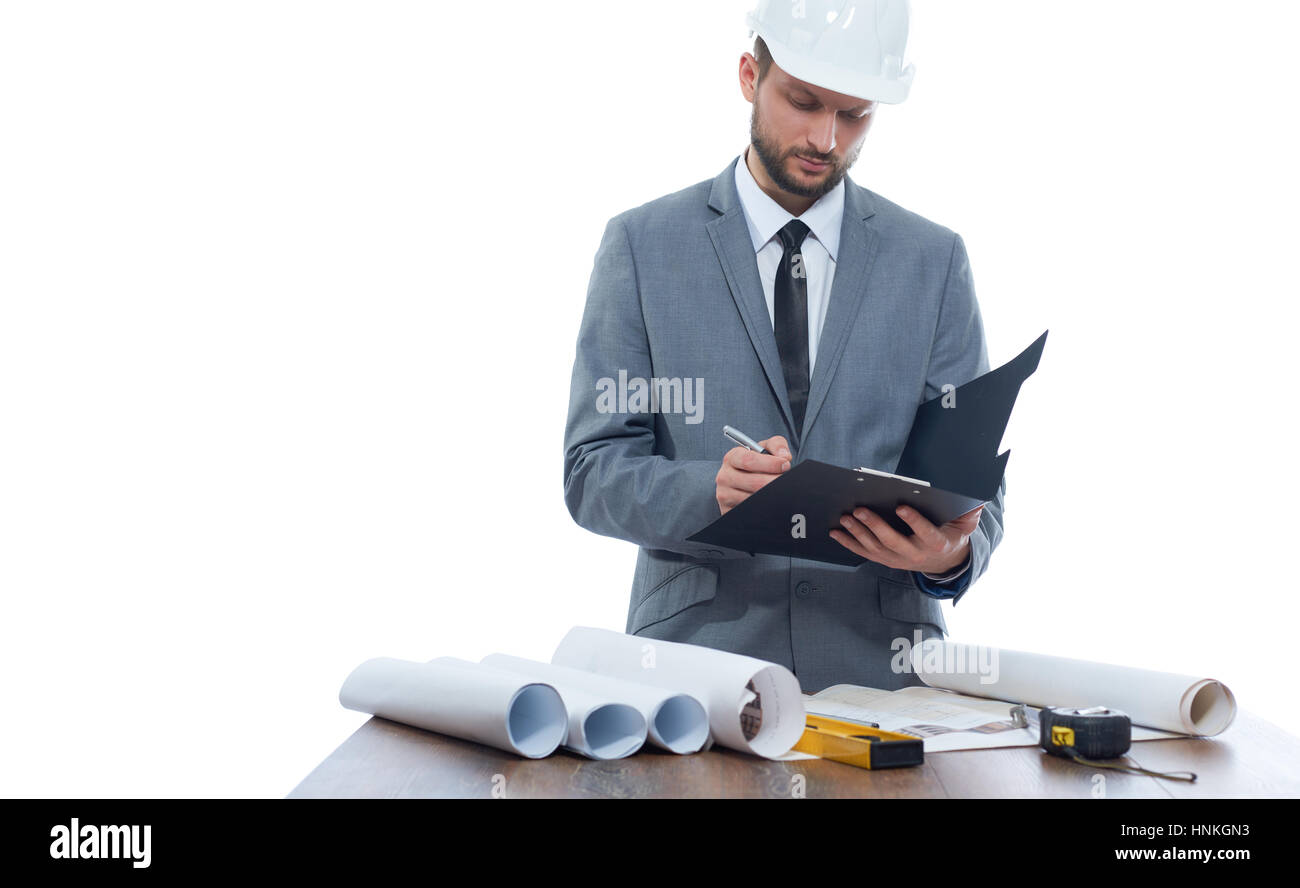 Architect writing report and reading architecture plan of building ...