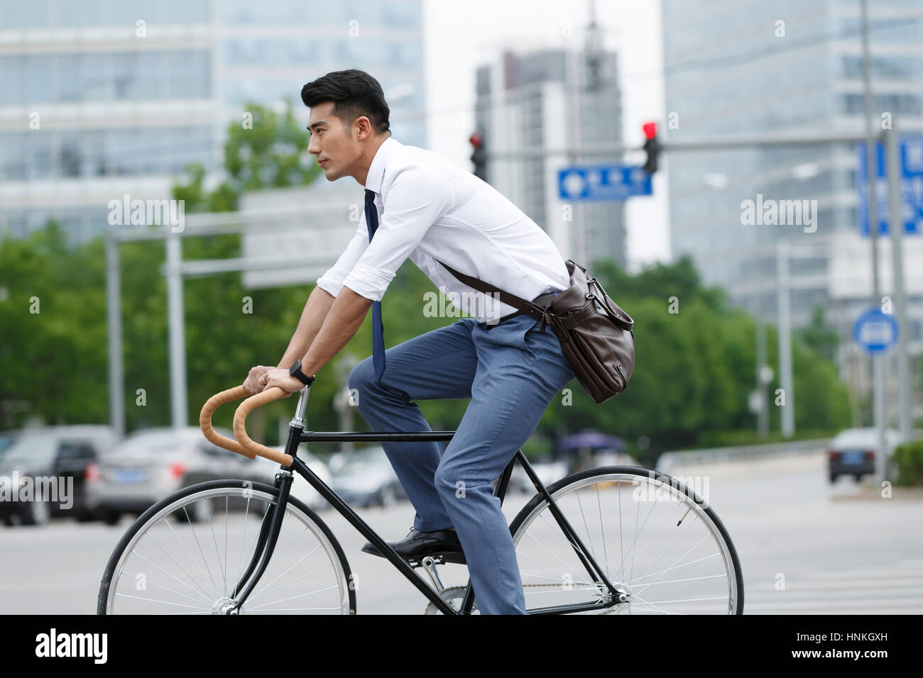 Young man riding a bicycle Stock Photo - Alamy