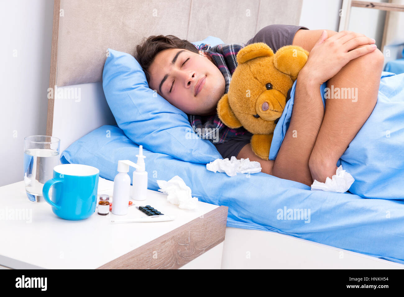 Sick man with flu lying in the bed Stock Photo - Alamy