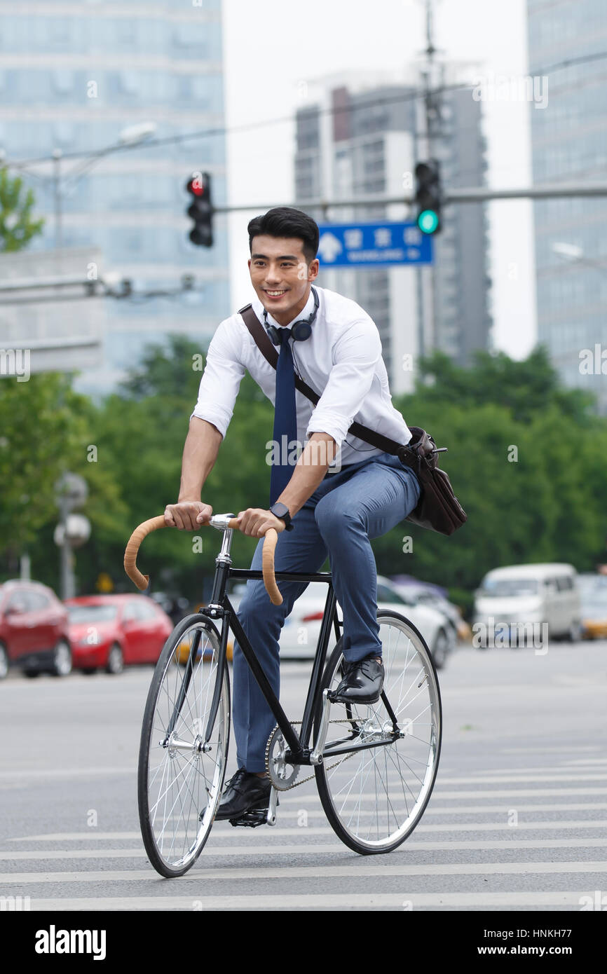 Young man riding a bicycle Stock Photo - Alamy