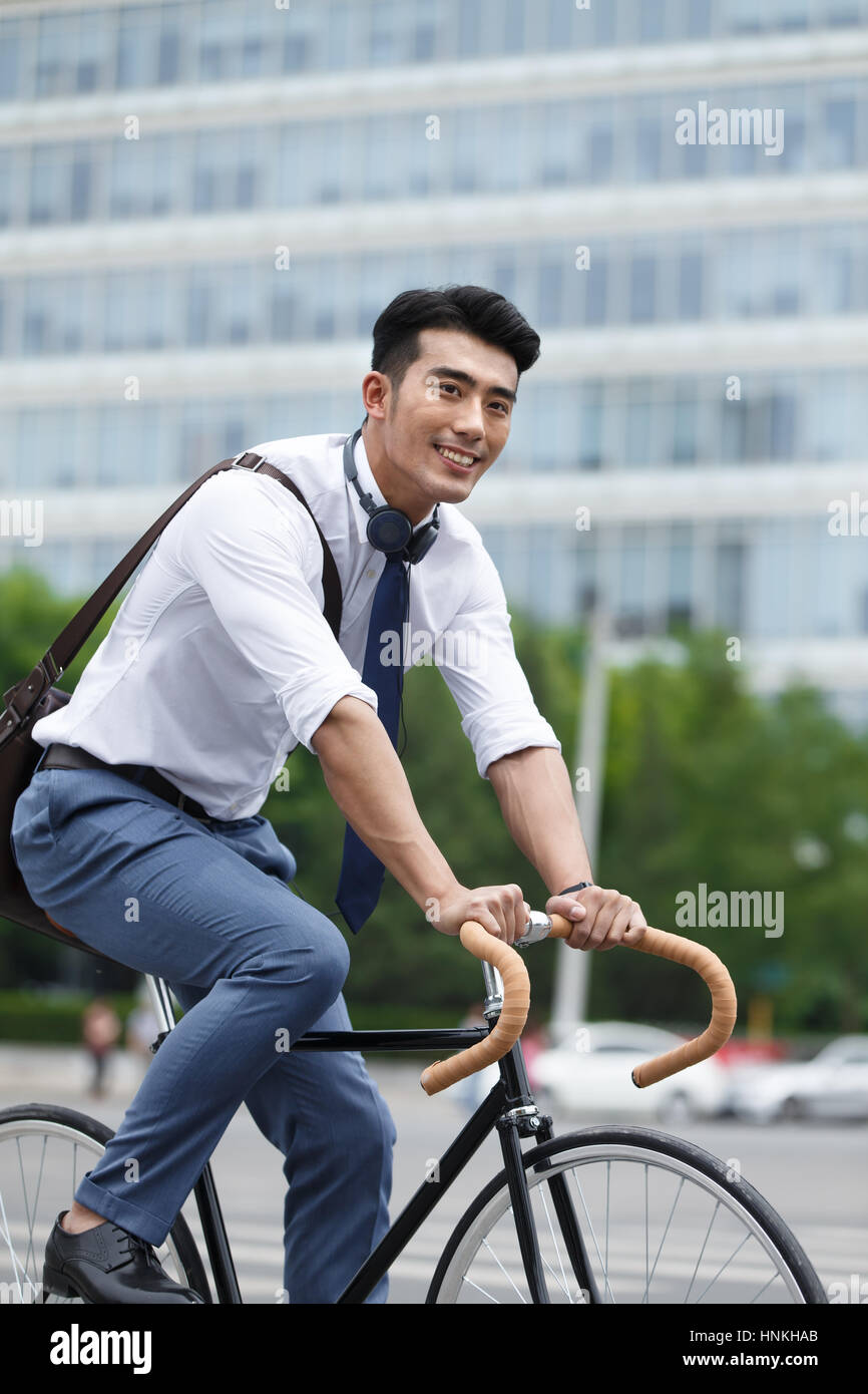 Young man riding a bicycle Stock Photo - Alamy