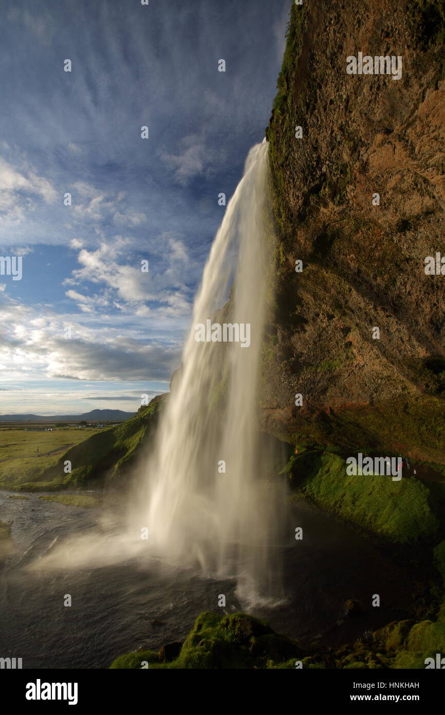 Seljalandsfoss waterfall plunging 60m from the cliff above, Sudhurland ...