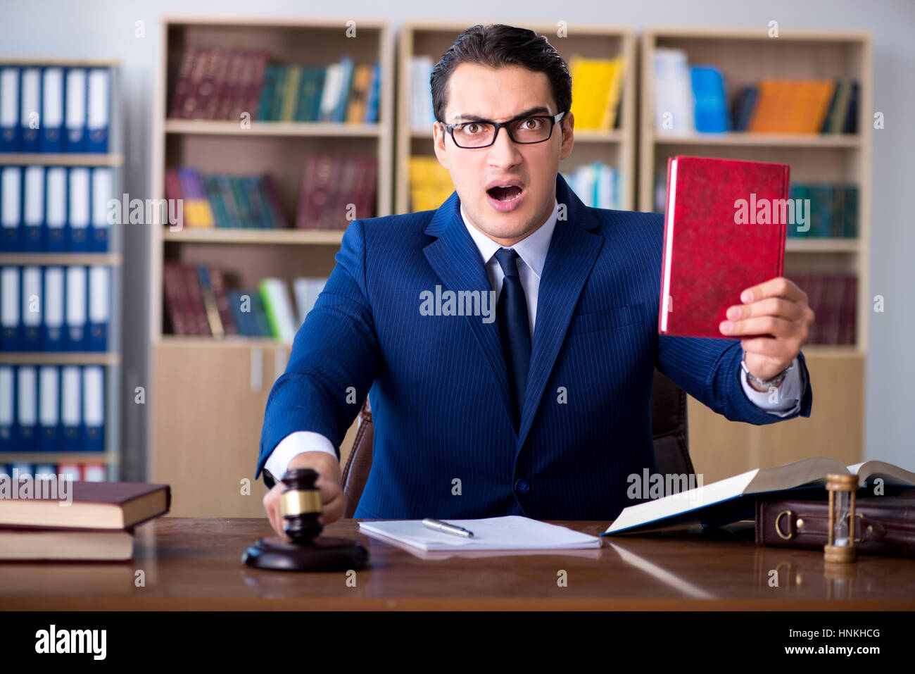Handsome judge with gavel sitting in courtroom Stock Photo - Alamy