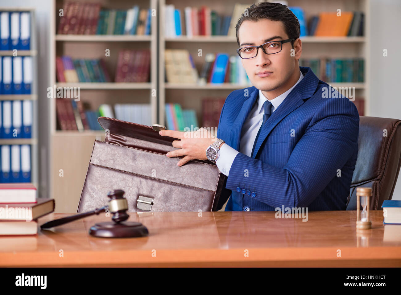 Handsome judge with gavel sitting in courtroom Stock Photo - Alamy