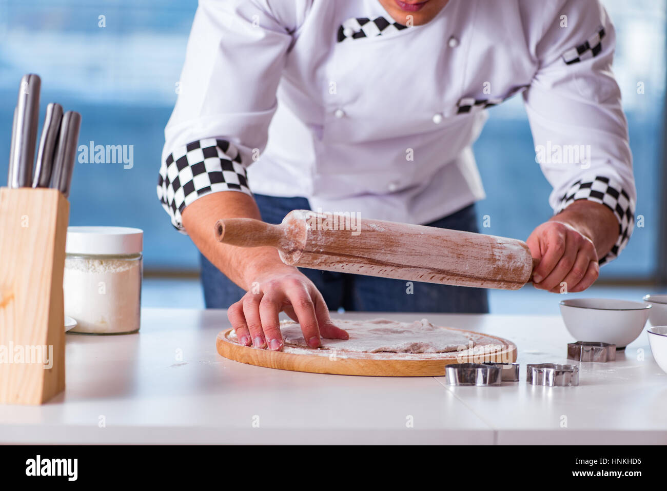 Young man cooking cookies in kitchen Stock Photo - Alamy