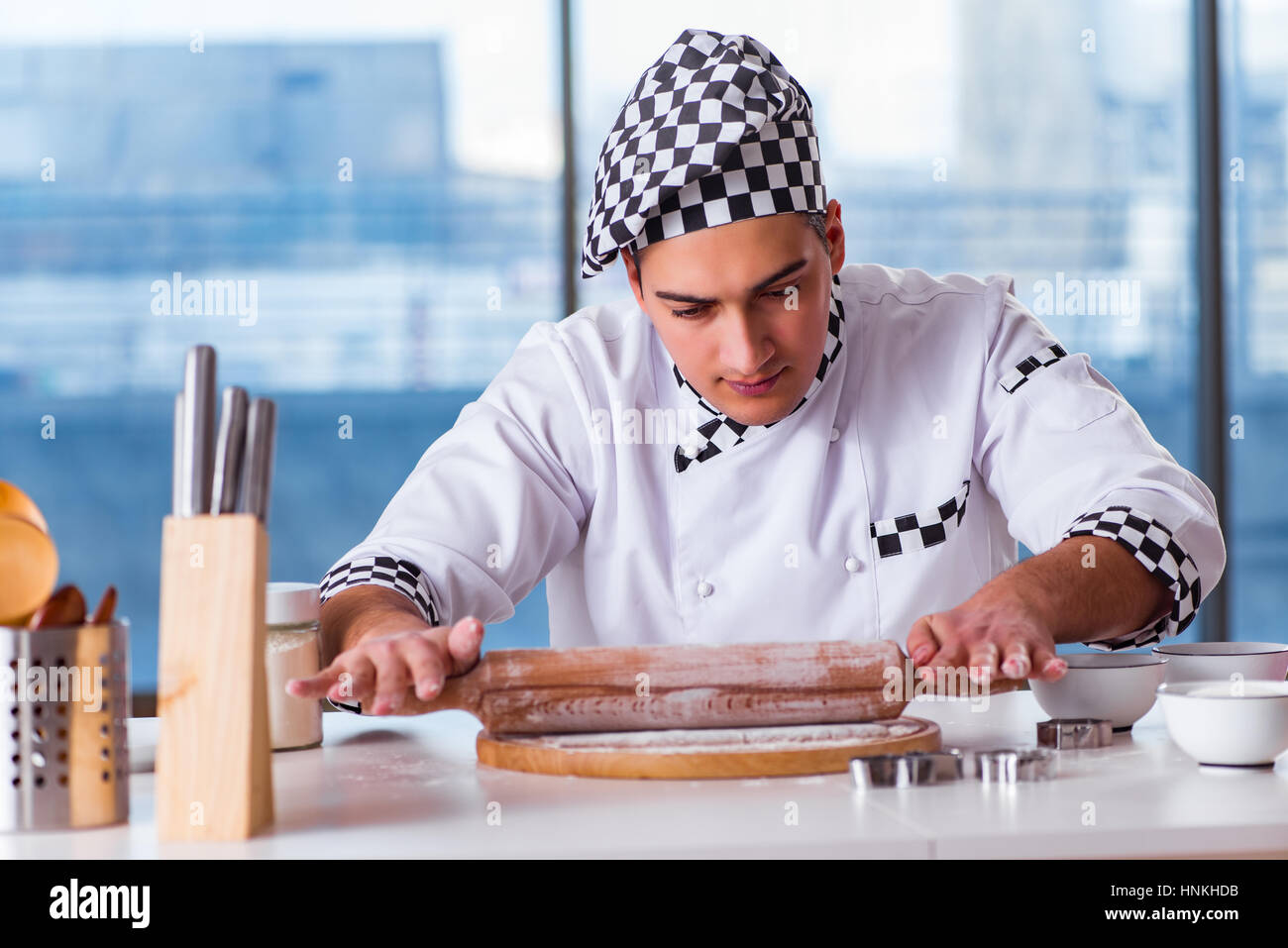 Young man cooking cookies in kitchen Stock Photo - Alamy