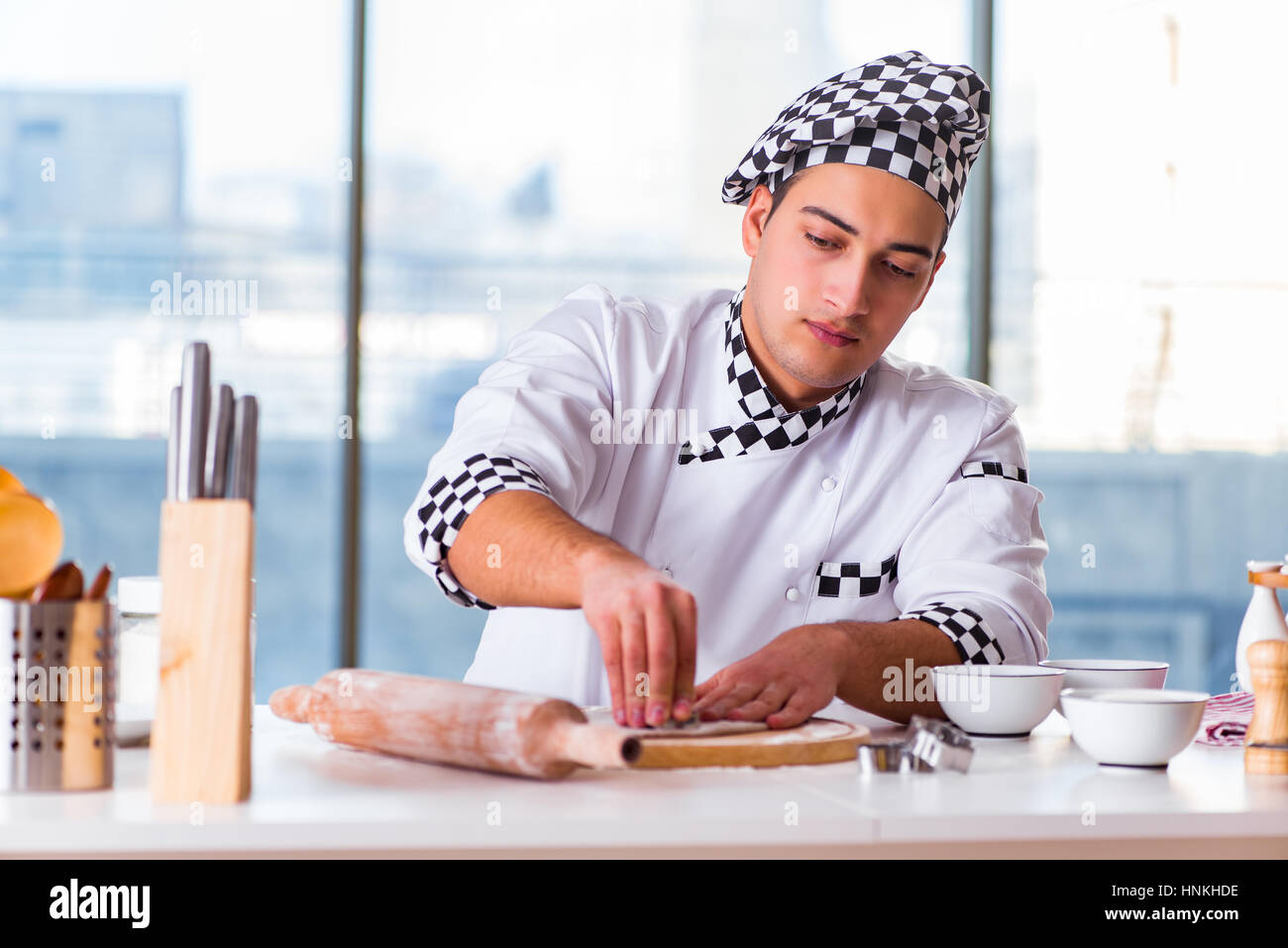 Young man cooking cookies in kitchen Stock Photo - Alamy