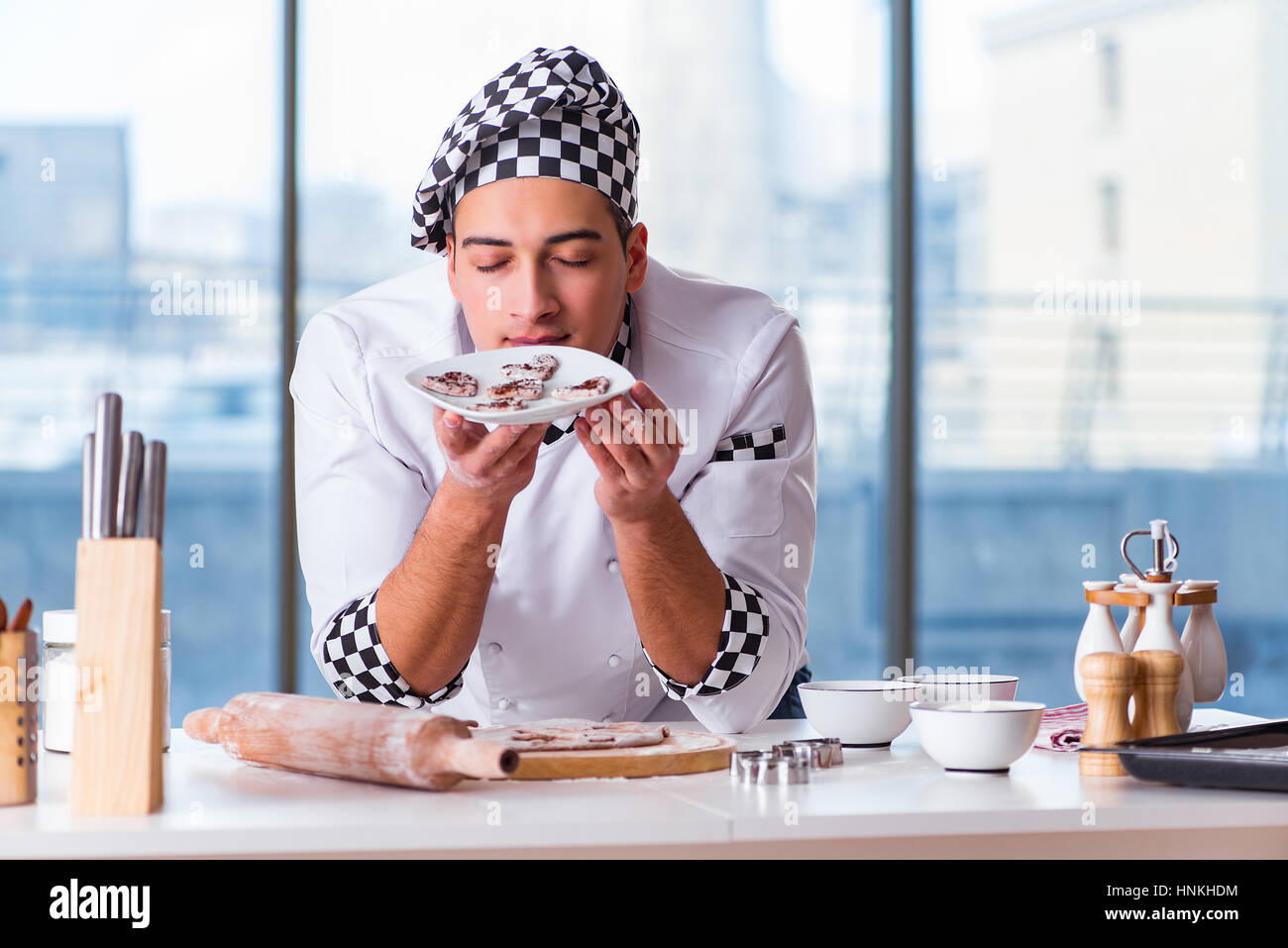 Young man cooking cookies in kitchen Stock Photo - Alamy