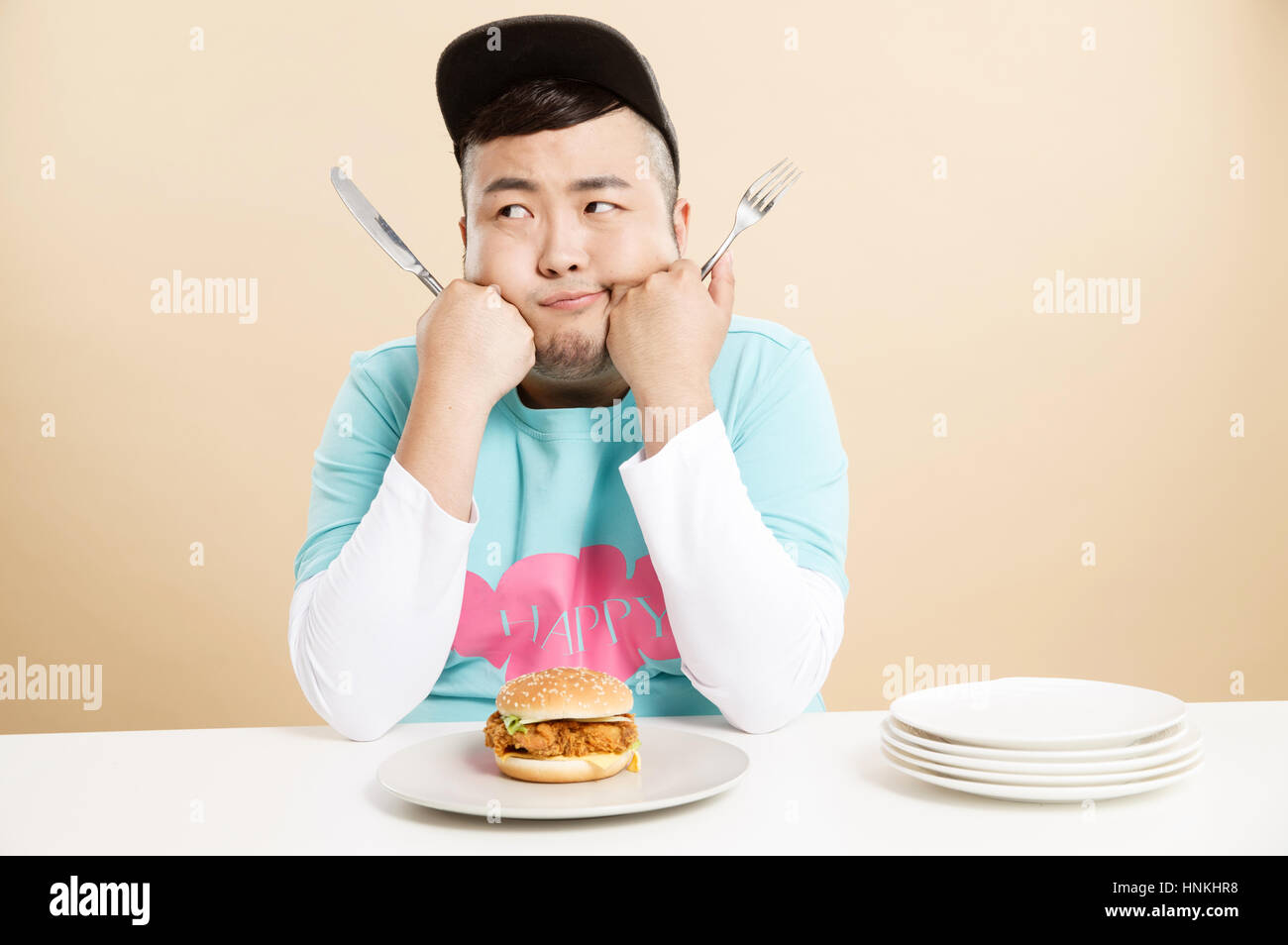 Little fat man eating hamburgers Stock Photo - Alamy