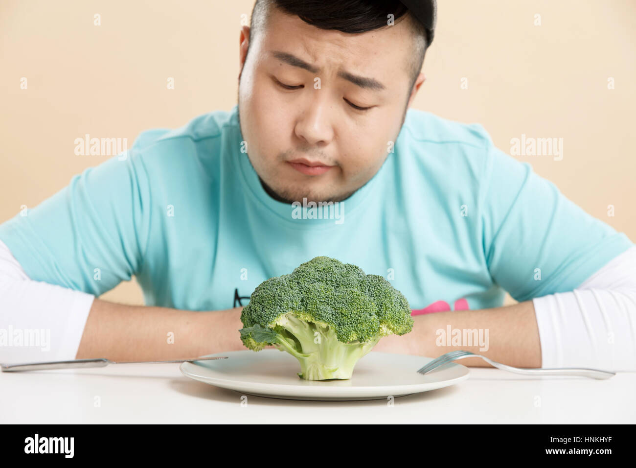 Fat man eating on the table hi-res stock photography and images - Alamy