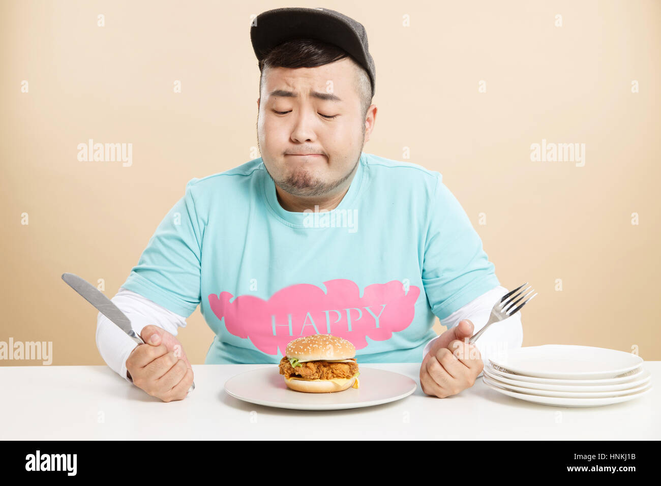 Little fat man eating hamburgers Stock Photo - Alamy