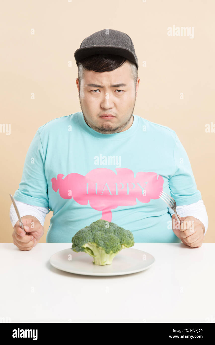 Little fat man eating vegetables Stock Photo - Alamy