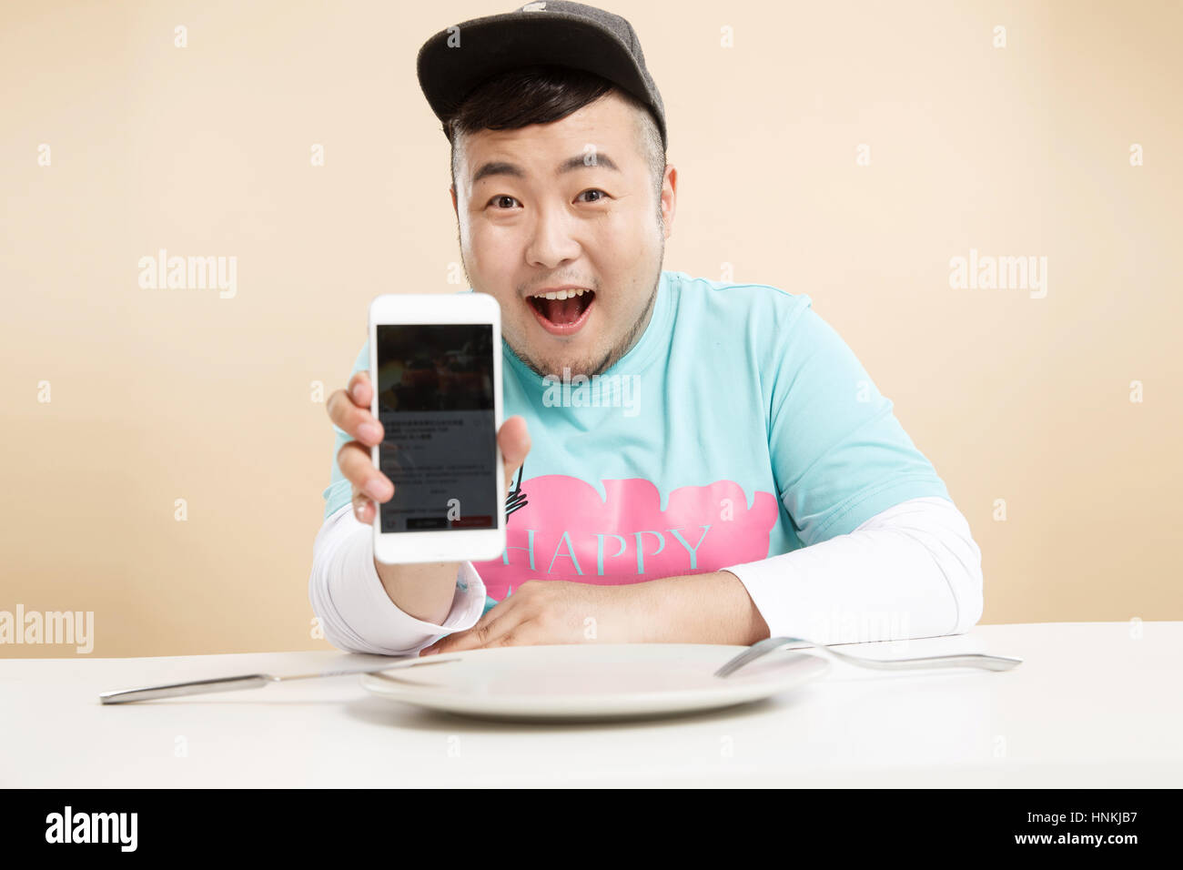 Little fat man using a cell phone Stock Photo - Alamy