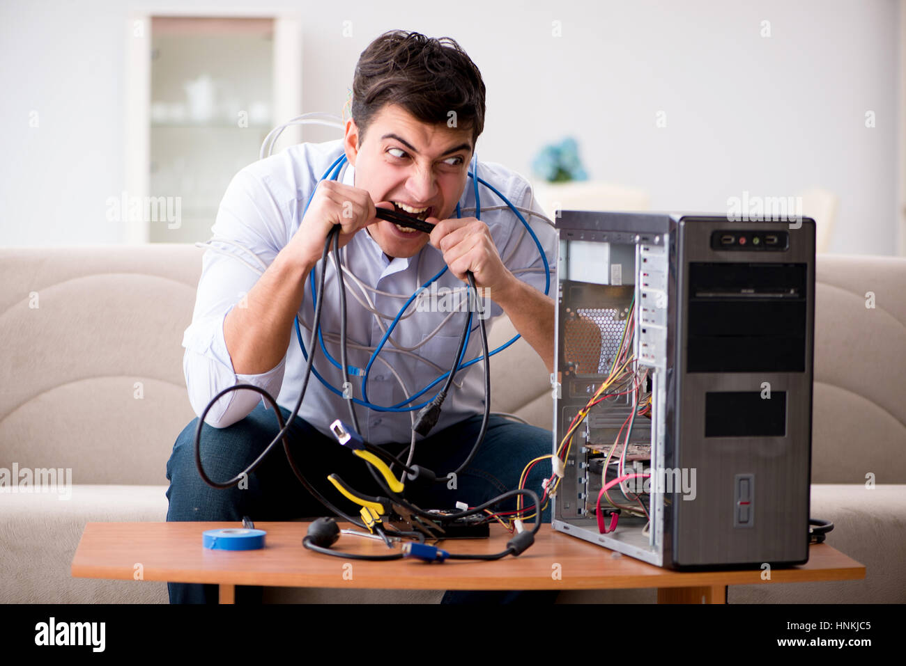Frustrated man with broken pc computer Stock Photo - Alamy