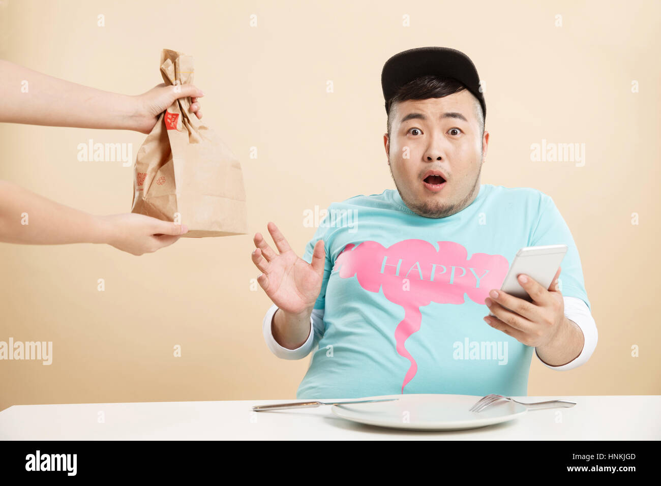Small fat man mobile phone ordering Stock Photo - Alamy