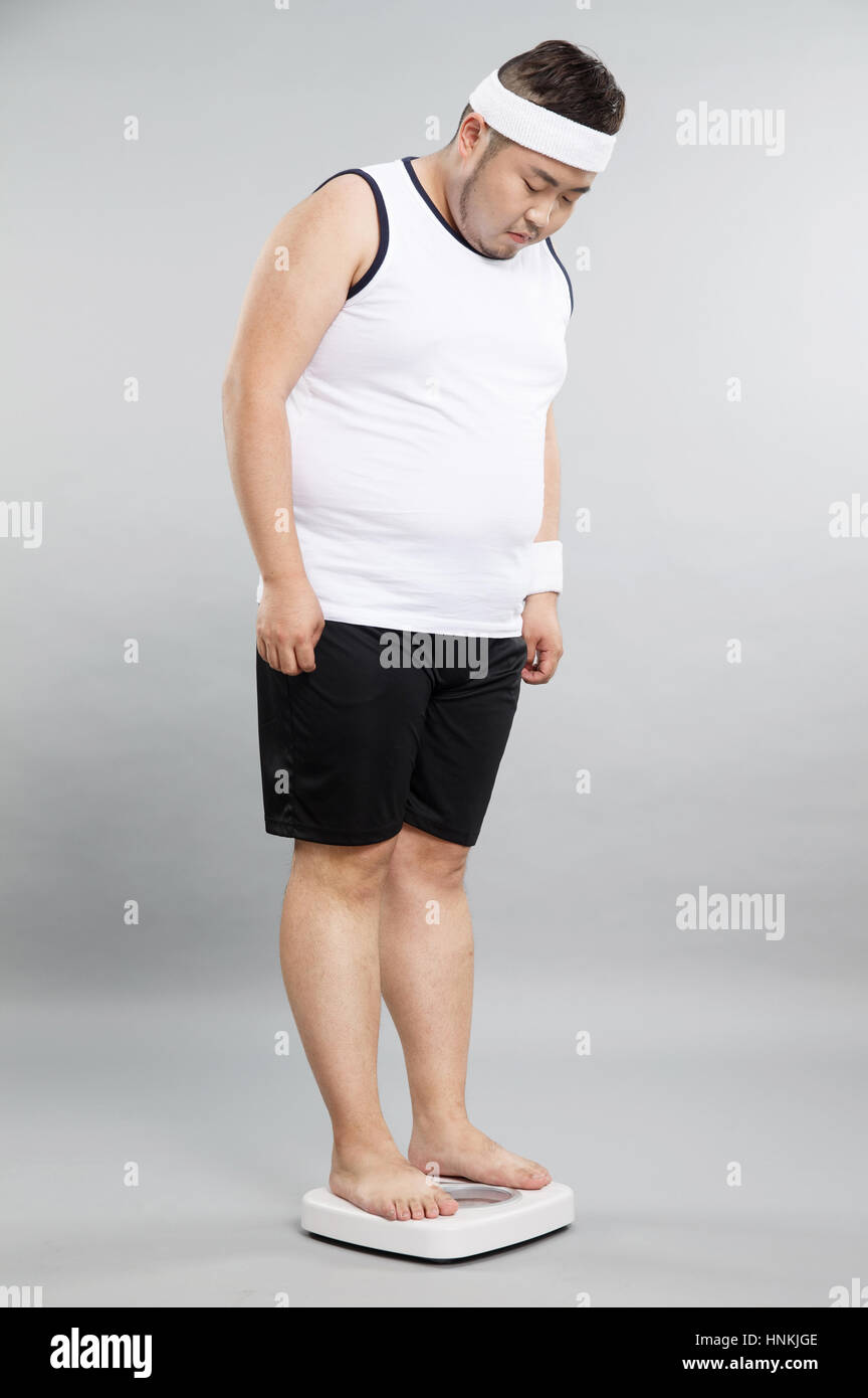 Man scale weight worried hi-res stock photography and images - Alamy