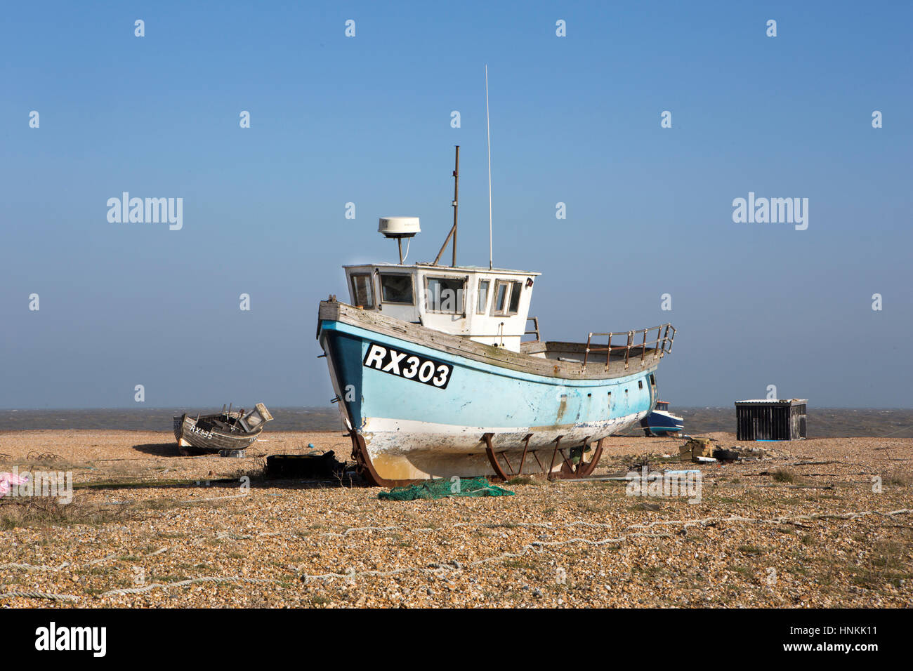 An old fishing boat on a shingle beach Stock Photo - Alamy
