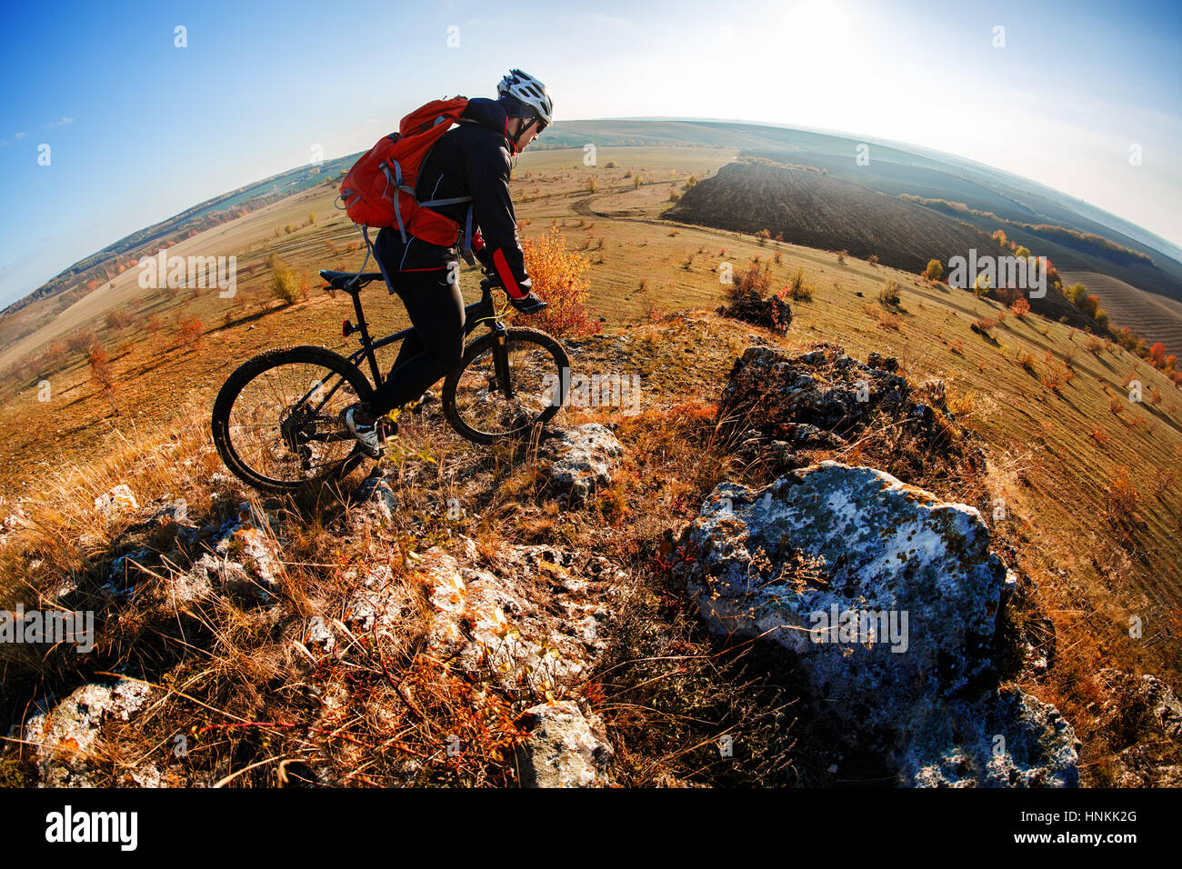Wide angle view of a cyclist riding a bike on a nature trail in the ...