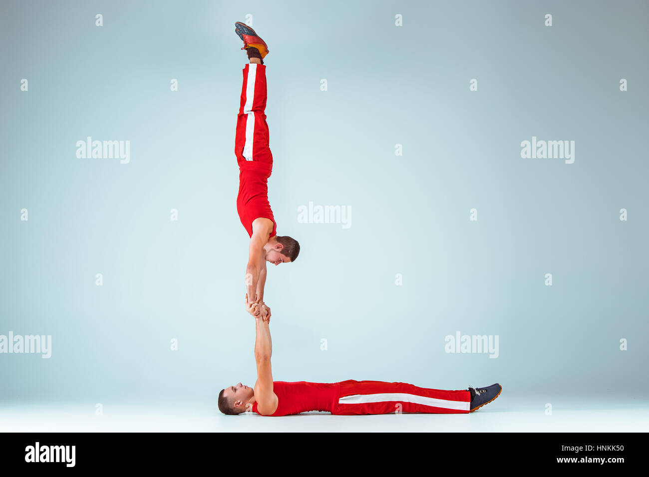The two gymnastic acrobatic caucasian men posing in balance posture on ...