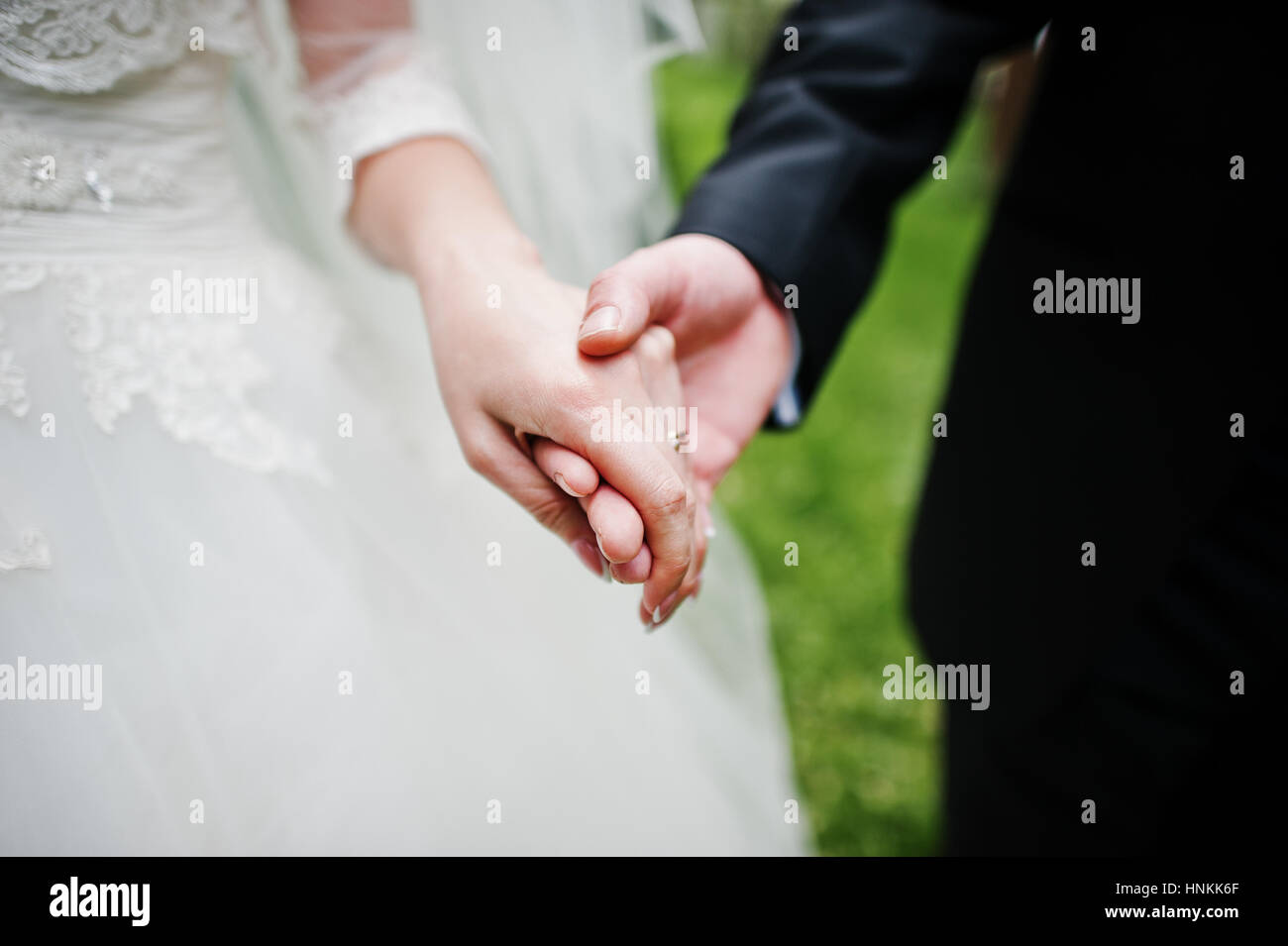 Close up hand in hand of wedding couple Stock Photo - Alamy