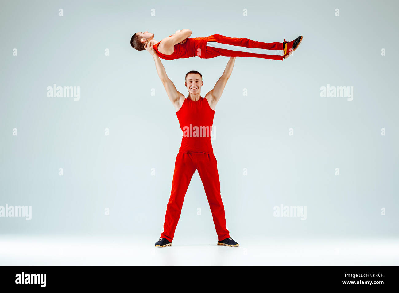 The two gymnastic acrobatic caucasian men posing in balance posture on ...