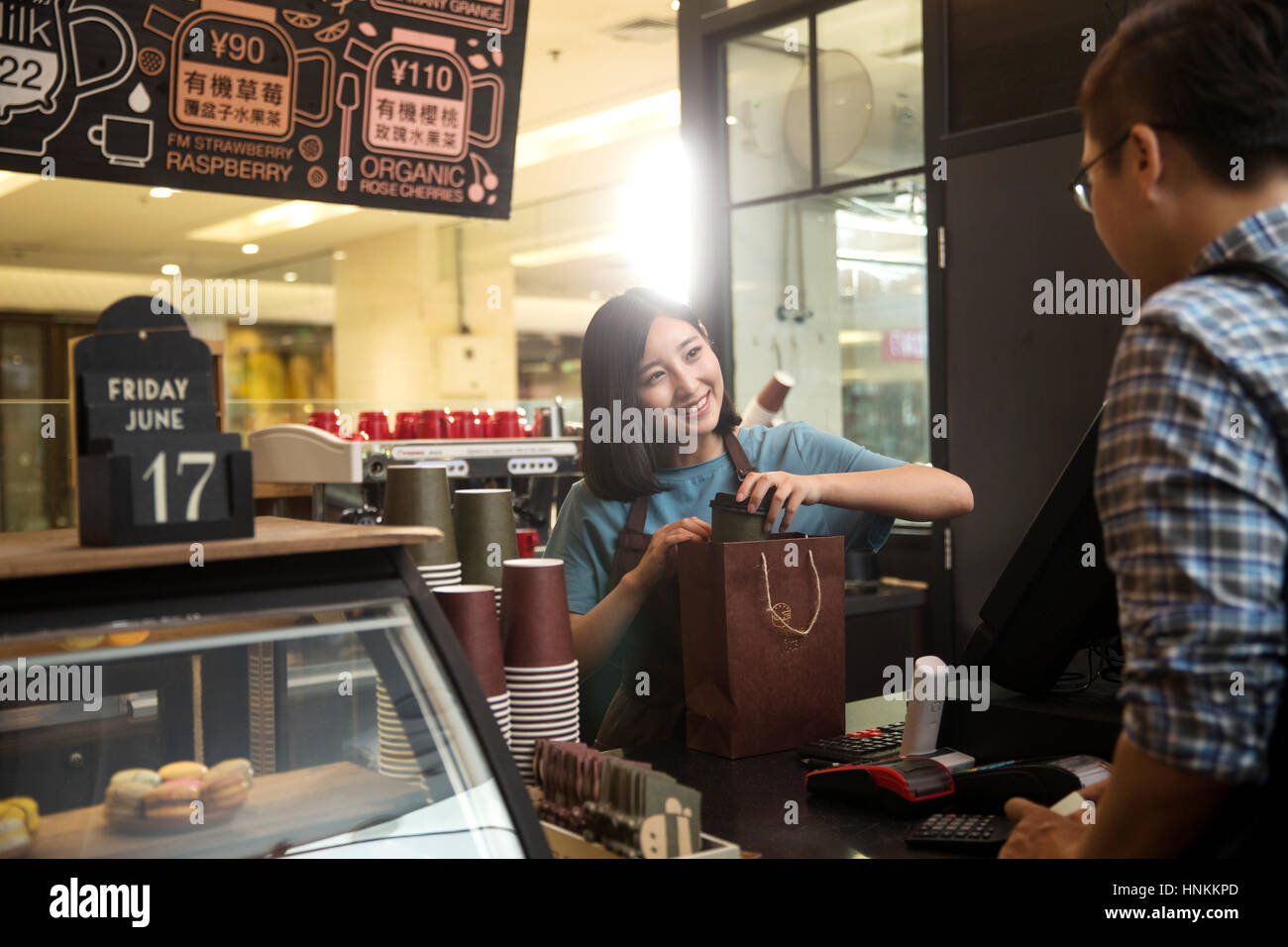 Cafe cashier and customer Stock Photo - Alamy