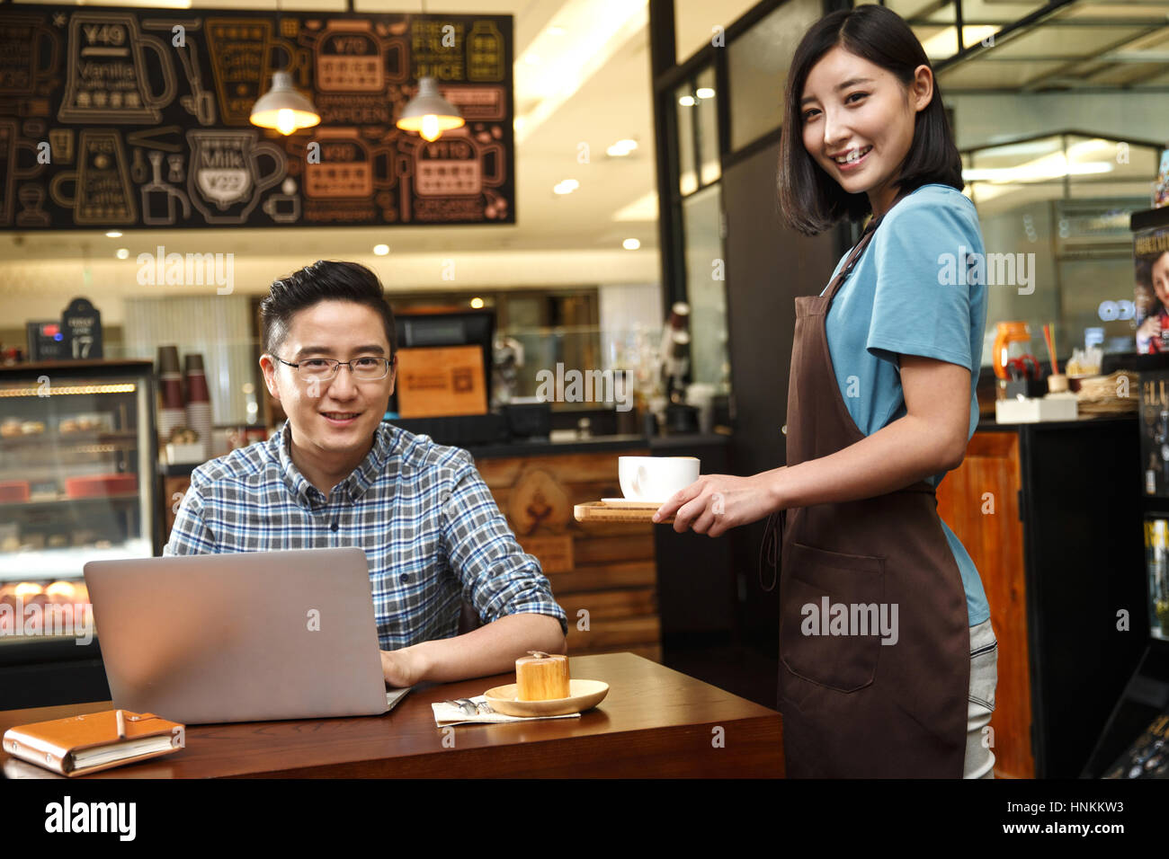 The waiter and the customer in the cafe Stock Photo - Alamy