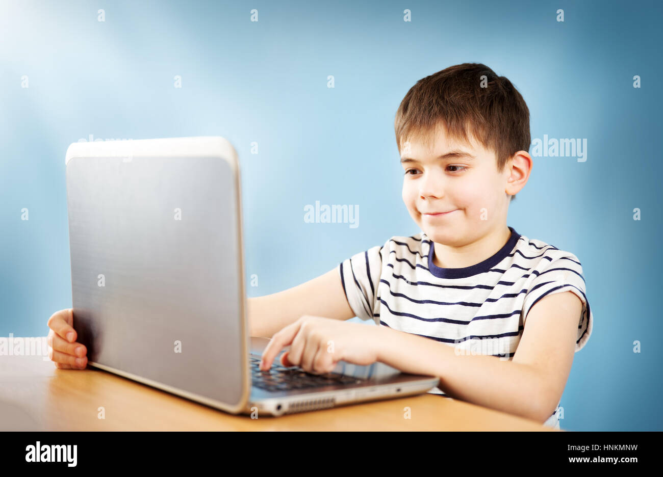 seven years old child sitting with a laptop Stock Photo - Alamy