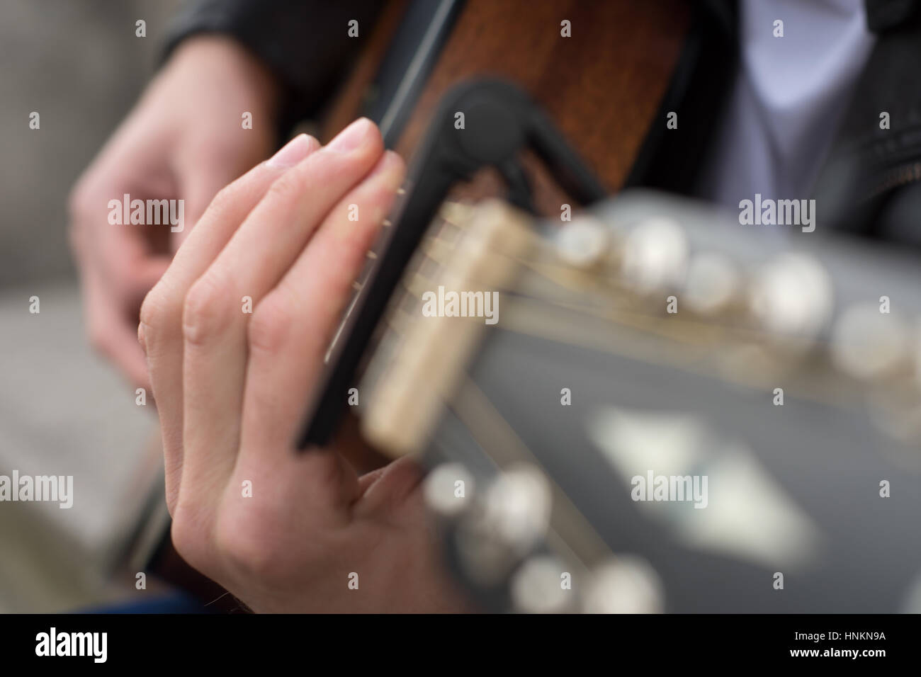 Acoustic guitar close-up with fingers playing it Stock Photo - Alamy
