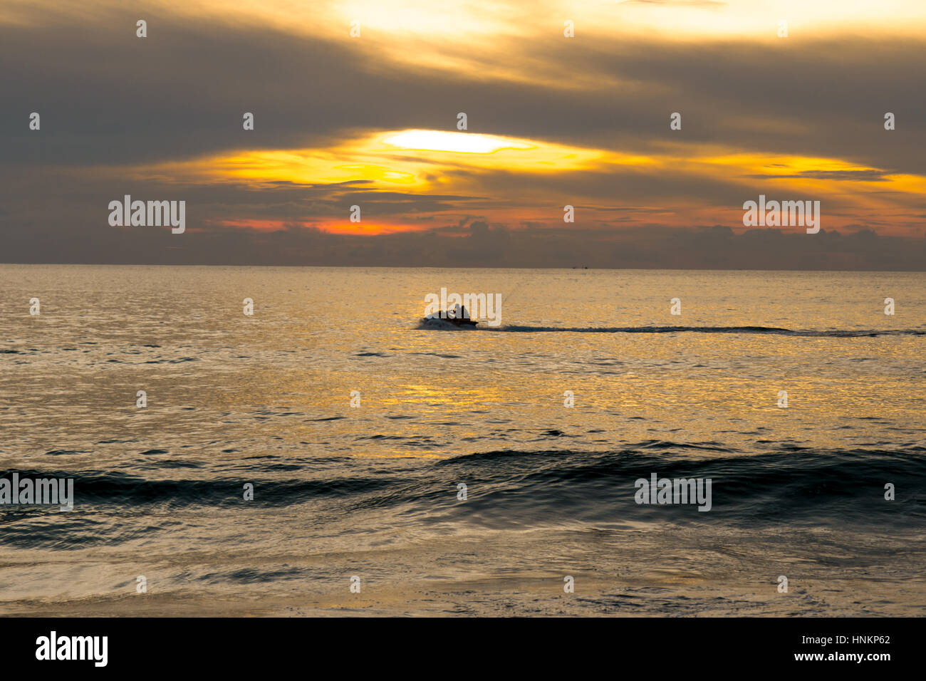 Evening on the sea and the sun gradually disappearing behind the ...