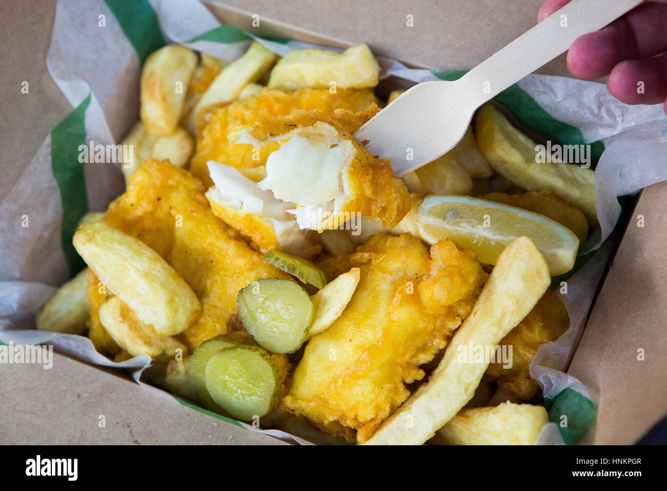 Fish n Chips eaten by caucasian male Stock Photo - Alamy