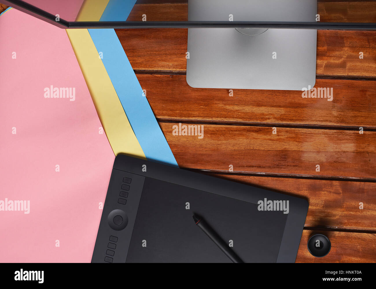 Wooden designer table view from top with graphic tablet and colorful ...