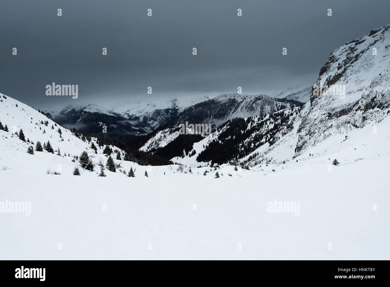 Panoramic view of a snow covered mountain range looking down valley ...