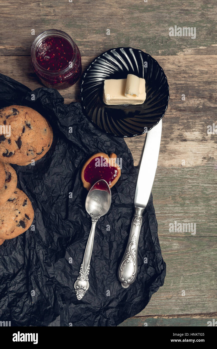 cookies and biscuits on black table background. Afternoon break time ...