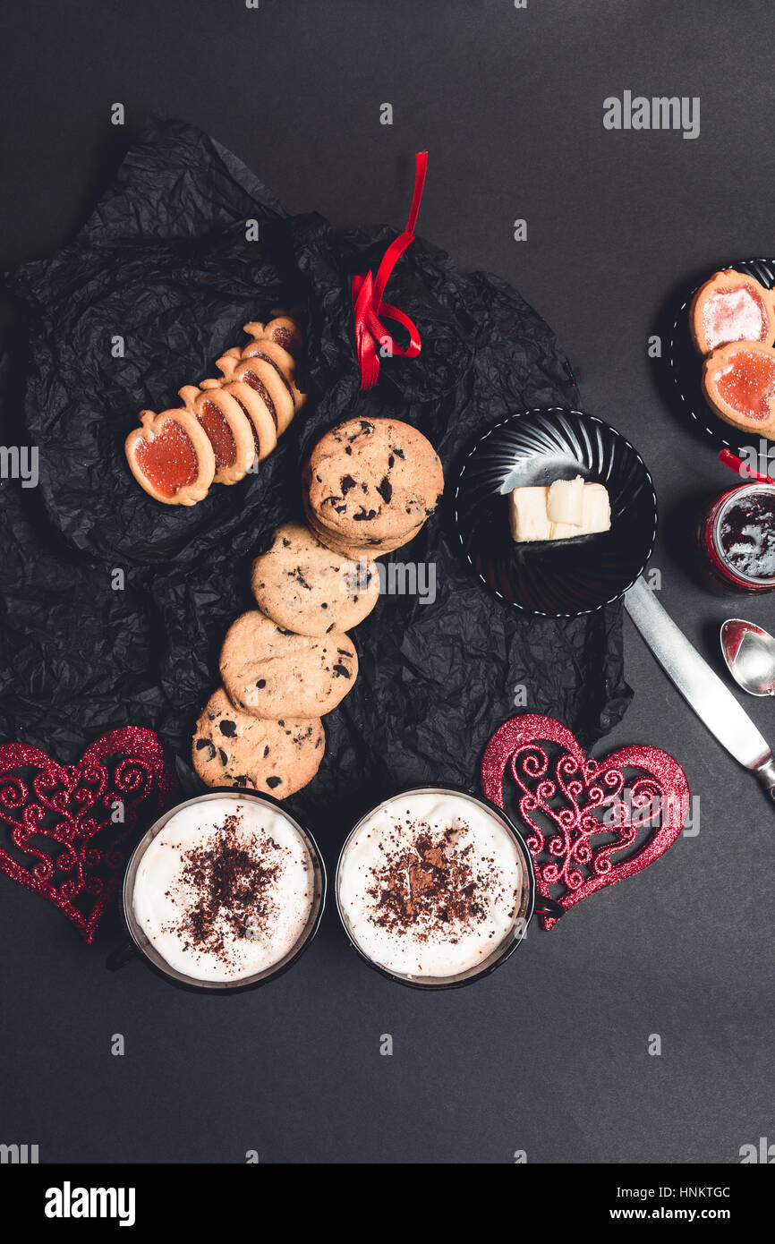 cookies and biscuits on black table background. Afternoon break time ...