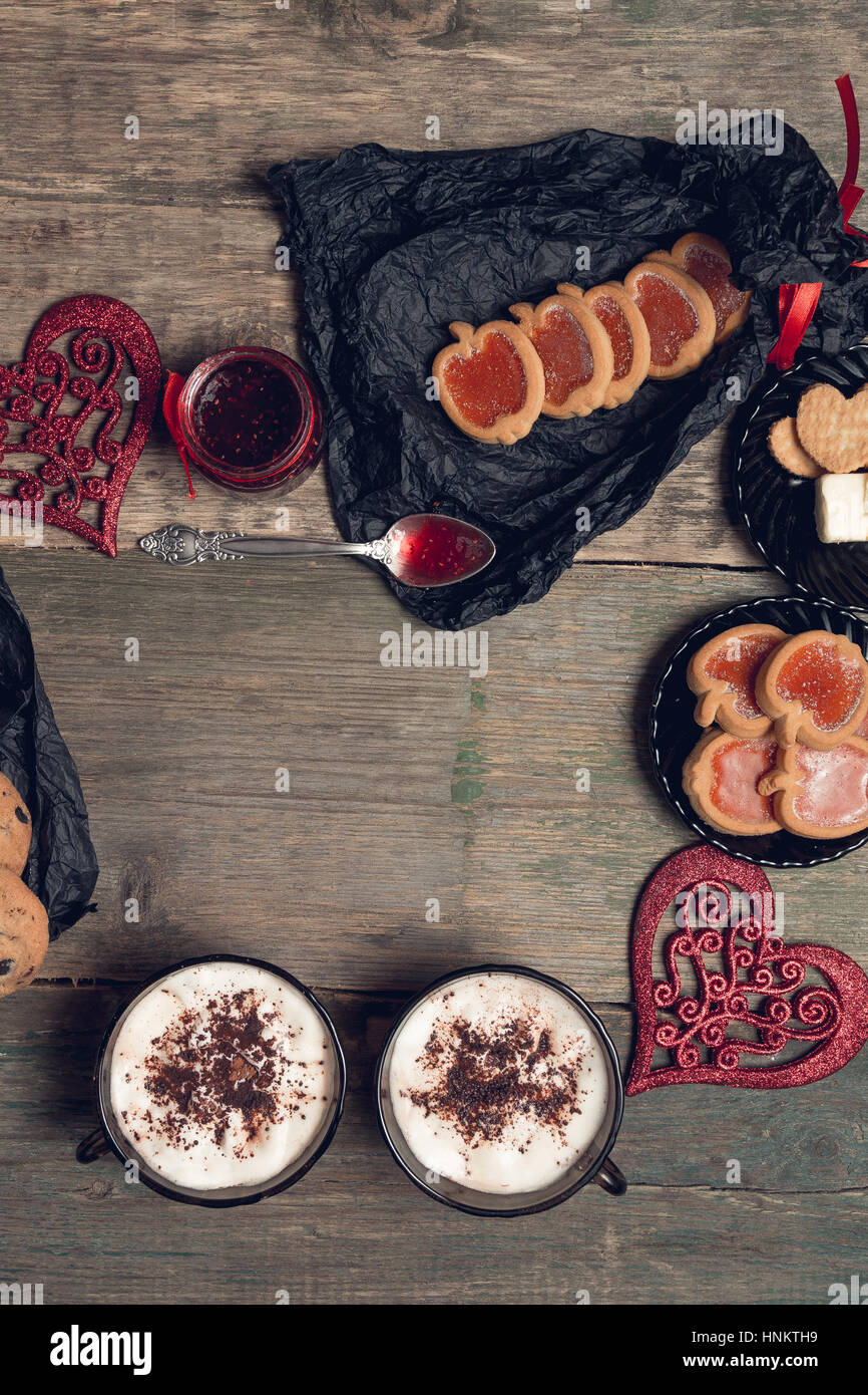 cookies and biscuits on black table background. Afternoon break time ...